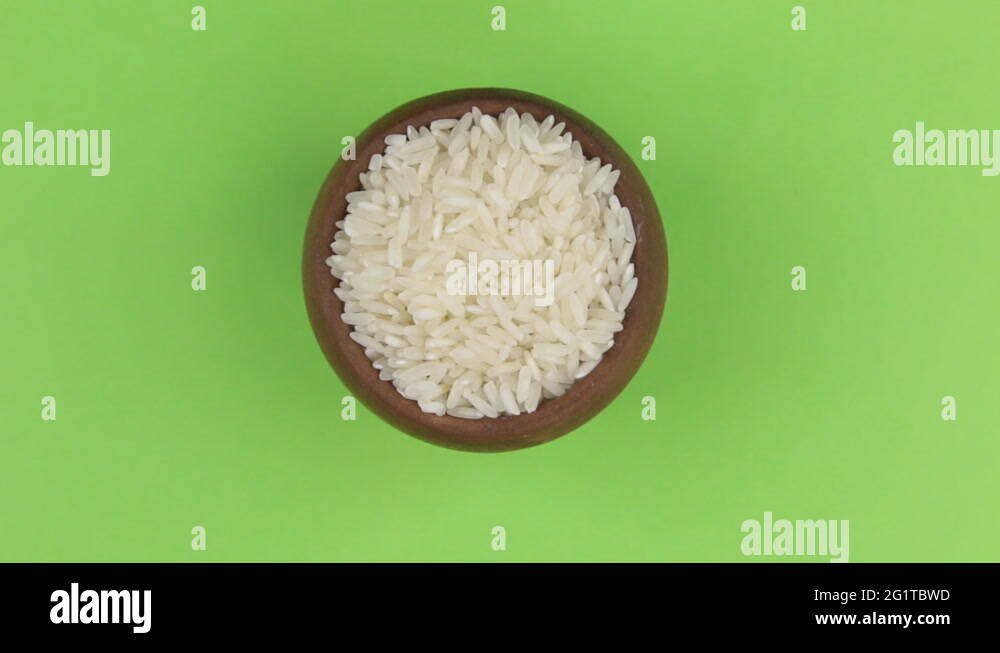 Rotation of the grain of rice in a pot isolated on green screen Stock ...