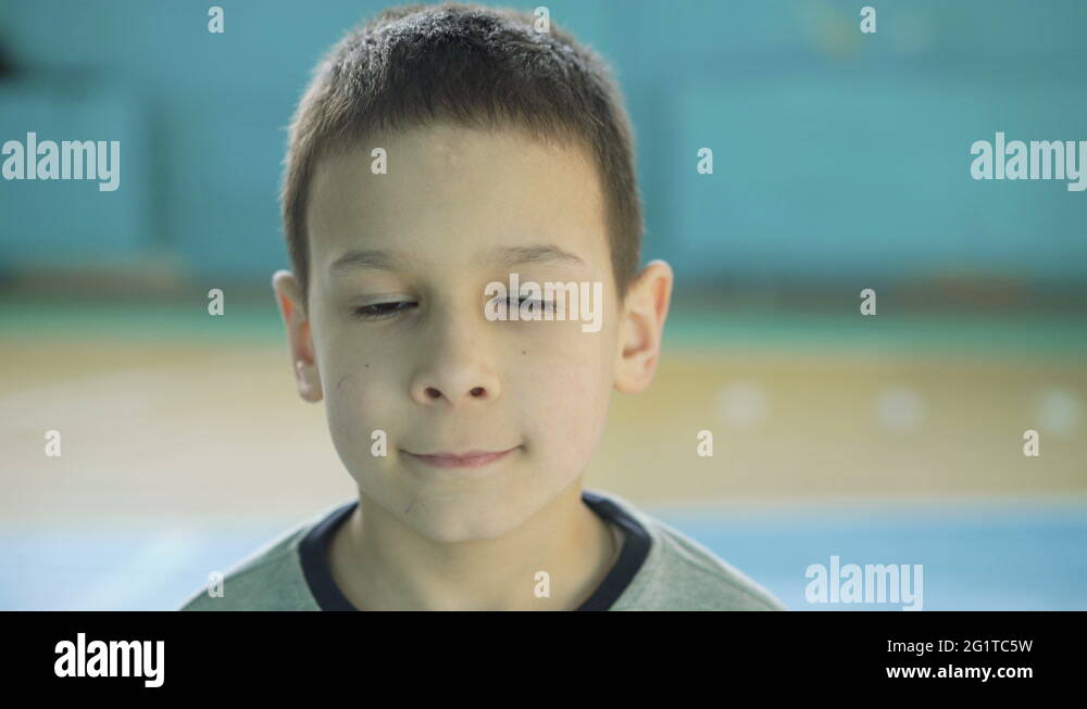 Funny handsome boy looking back and laughing at camera in the gym 4K ...