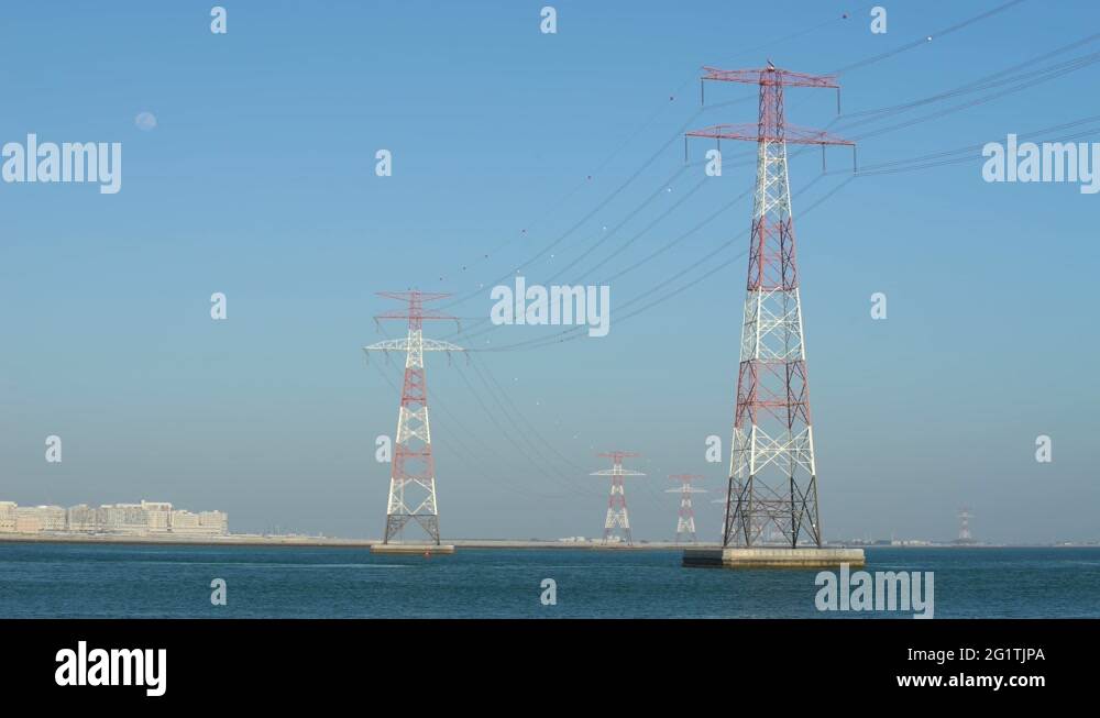 Power lines in water or river, long cables and wires in the sky. High ...