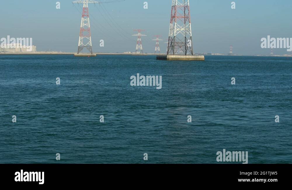 Power lines in water or river, long cables and wires in the sky. High ...