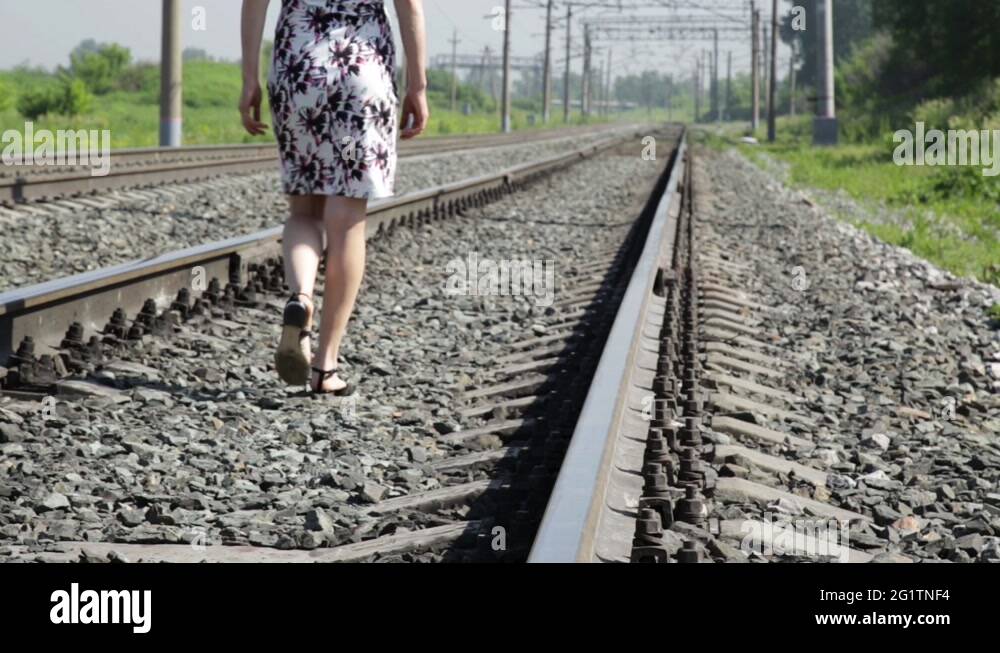 beautiful woman walking along railway tracks in a sun day Stock Video ...