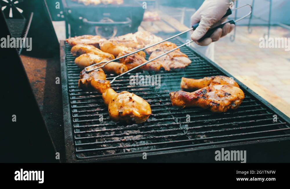 Chicken meat that turn over on a barbecue grill.Meat is fried in Mangal ...