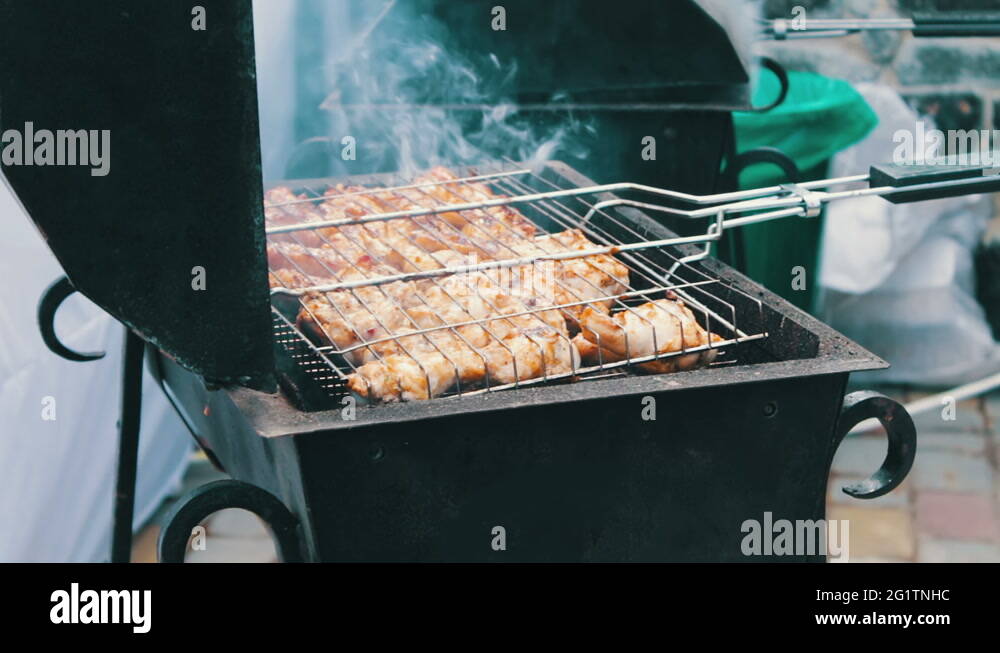 Chicken meat that turn over on a barbecue grill.Meat is fried in Mangal ...