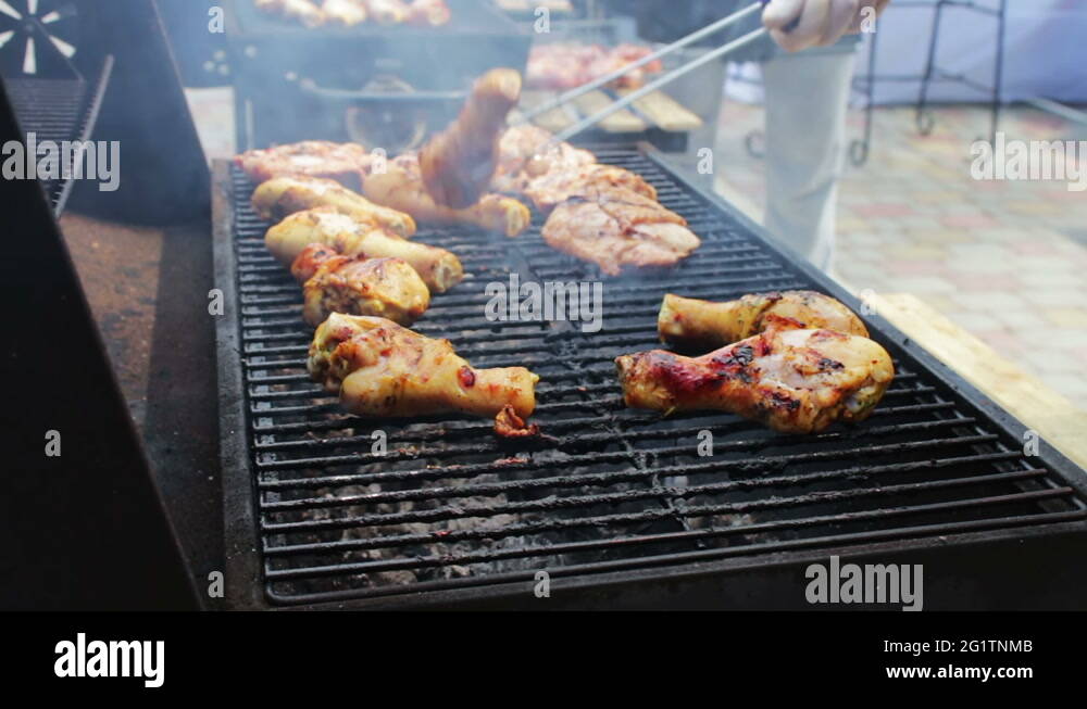 Chicken meat that turn over on a barbecue grill.Meat is fried in Mangal ...