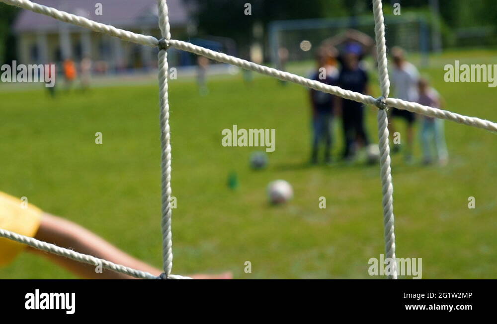 Children playing football (soccer) outside Stock Video Footage - Alamy