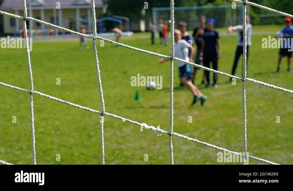 Children playing football (soccer) outside Stock Video Footage - Alamy