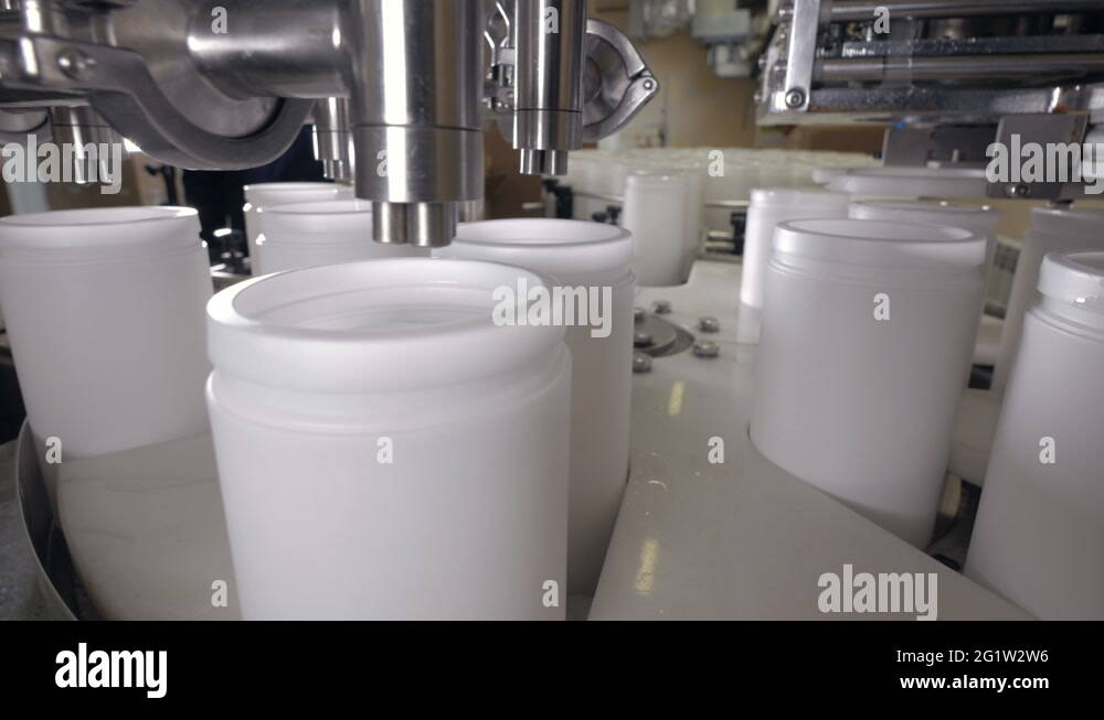 Filling of plastic containers at a factory Stock Video Footage - Alamy