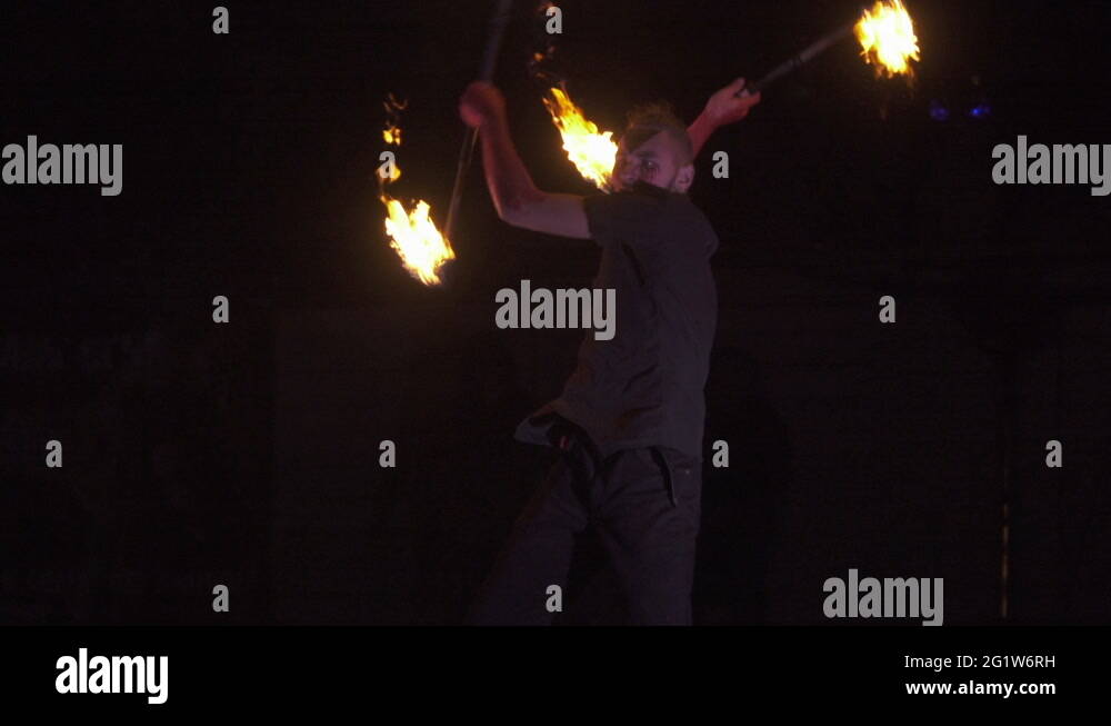 Fiery dance. Amazing magical Fire Show at night. Slow shutter speed ...