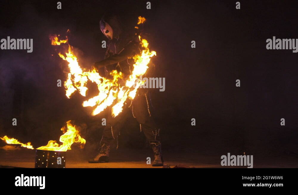 Fiery dance. Amazing magical Fire Show at night. Slow shutter speed ...
