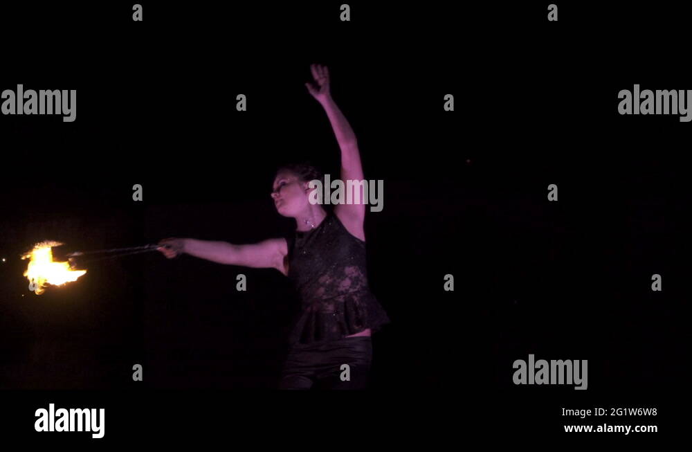 Fiery dance. Amazing magical Fire Show at night. Slow shutter speed ...