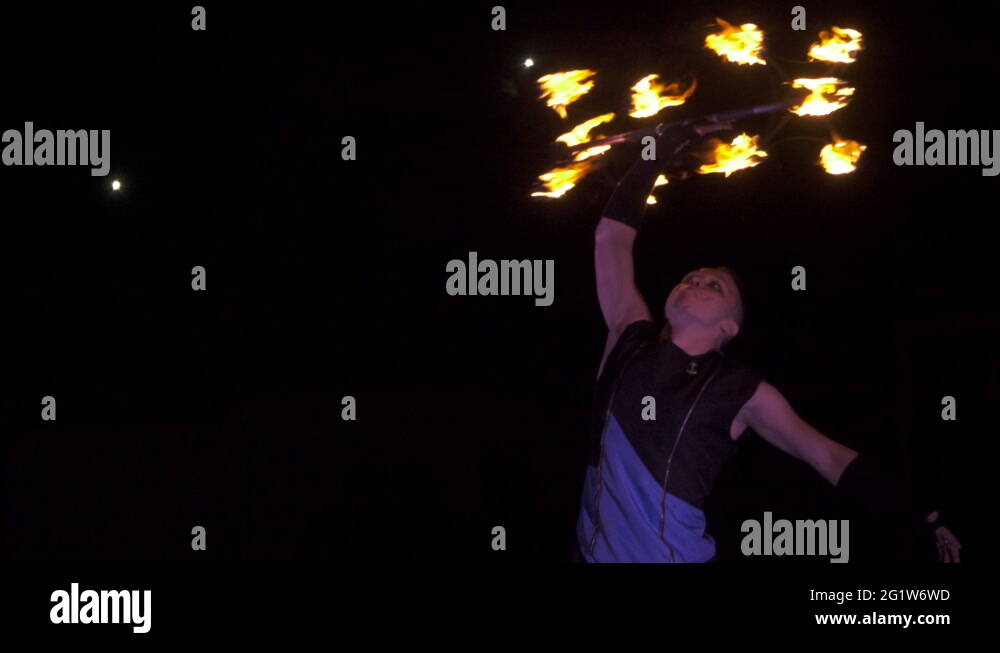 Fiery dance. Amazing magical Fire Show at night. Slow shutter speed ...