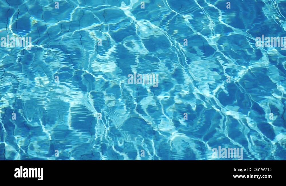 Refraction of sunlight in swimming pool water. Pool water surface ...