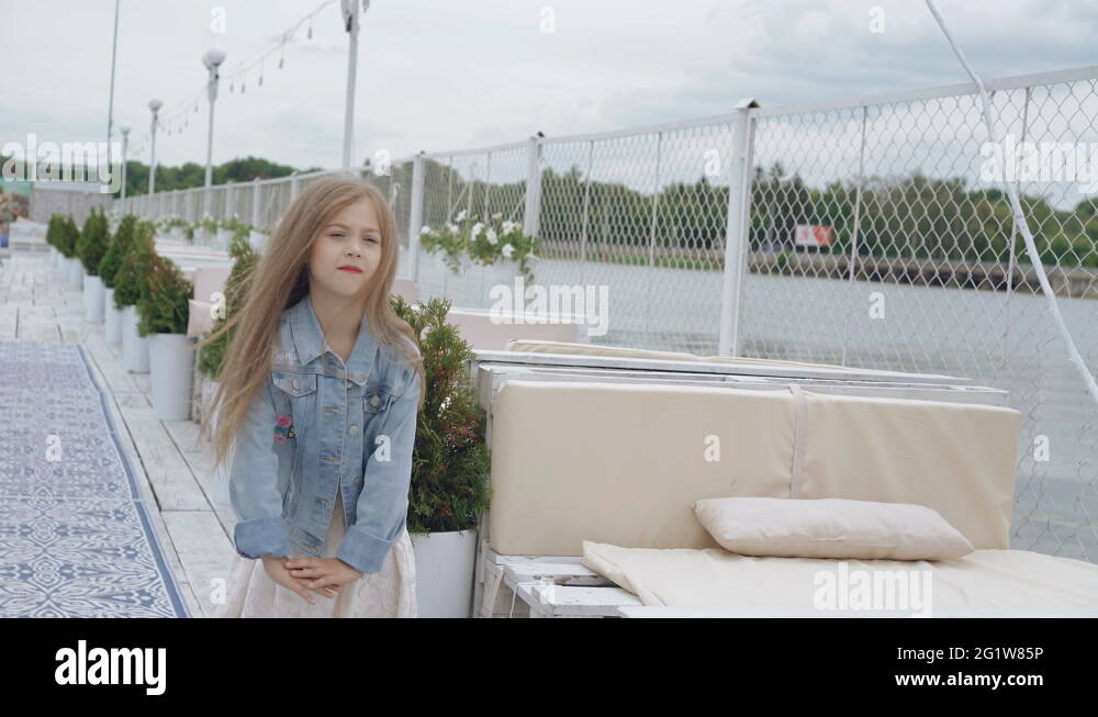 Stylish little model posing at camera in modern bay bar 4K Stock Video ...