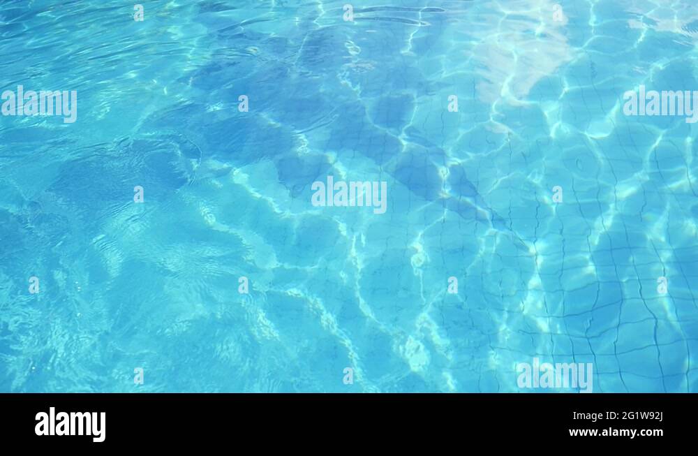 Refraction of sunlight in swimming pool water. Pool water surface ...