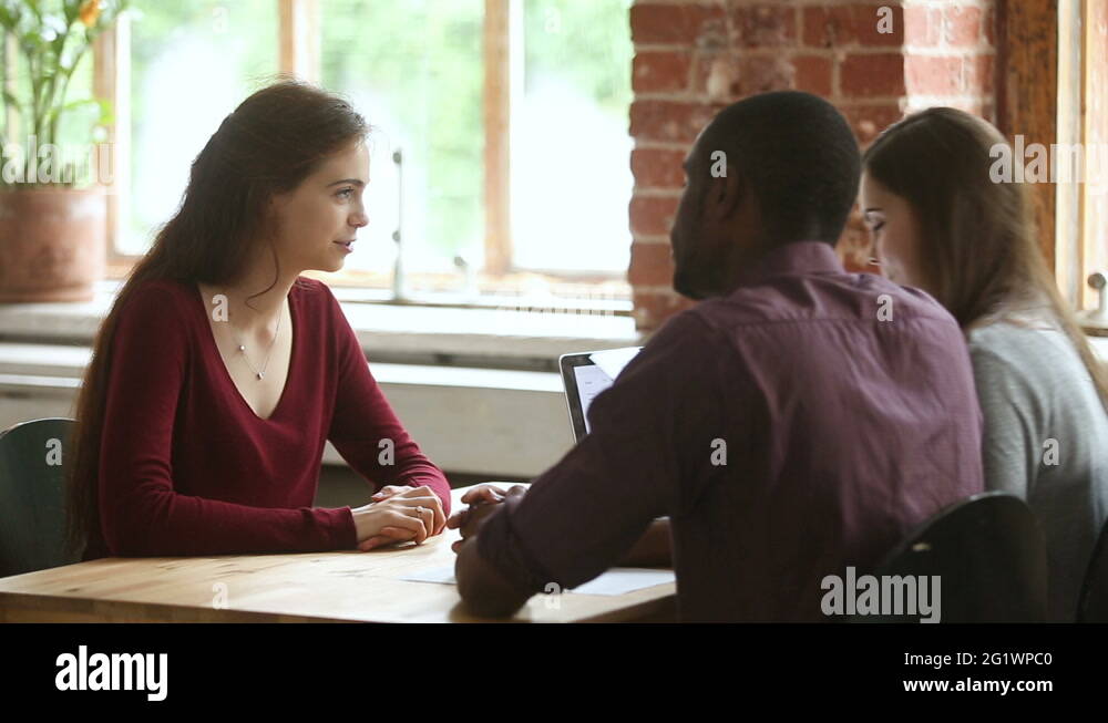Female applicant talking during job interview with multiracial hr ...