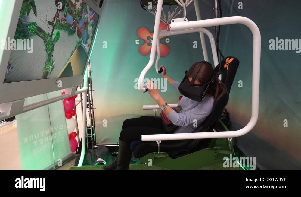 Girl uses virtual reality glasses flying on air balloon in video game ...