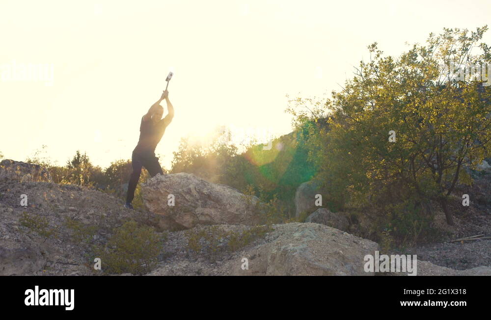 Strong man beating the rock with hammer. 4K Stock Video Footage - Alamy