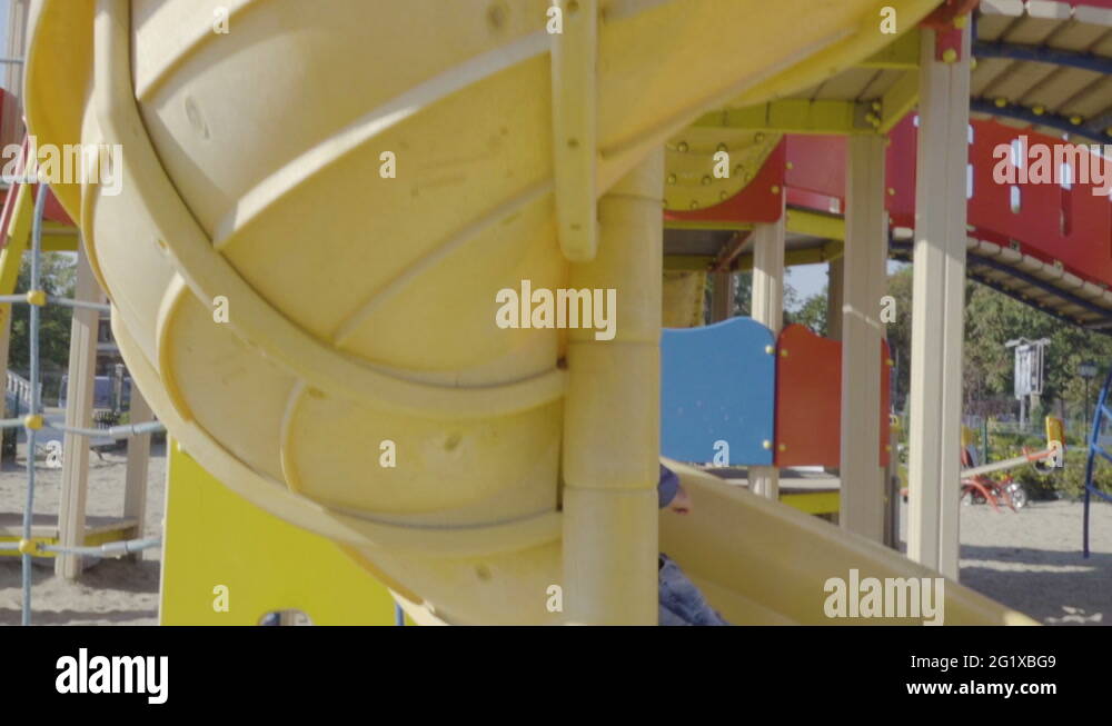 Kids having fun on slide. Happy children on slide at playground area ...