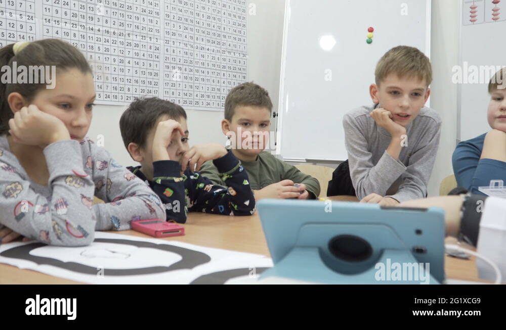 Group of elementary school children in classroom at lesson Stock Video ...