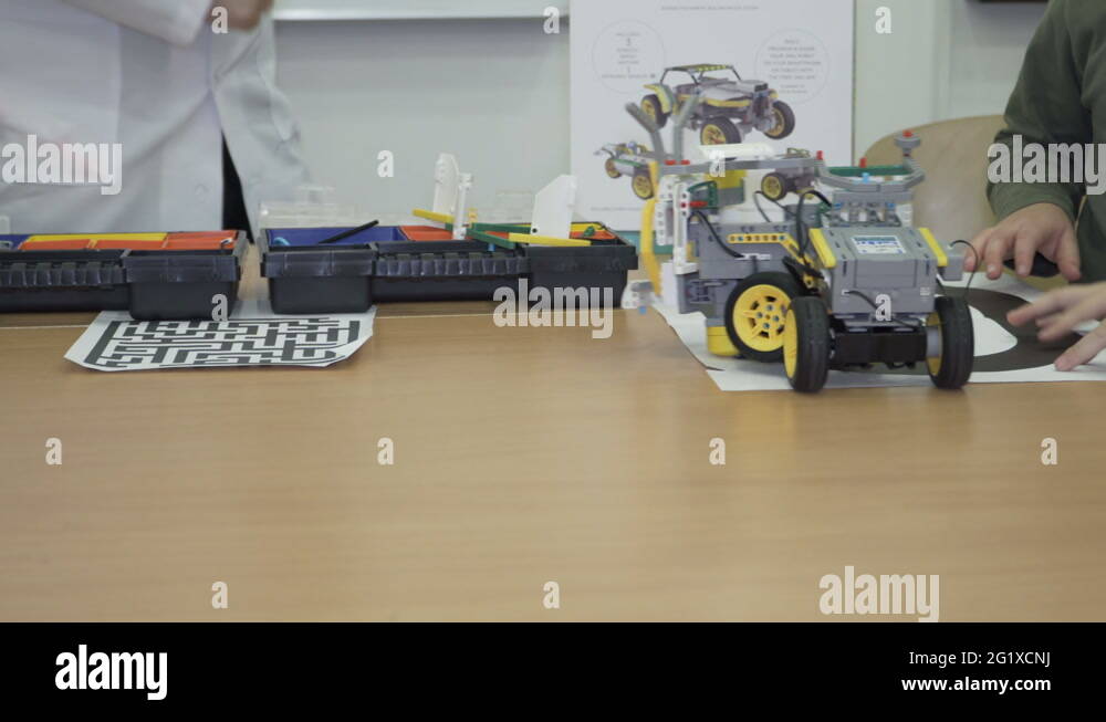 Shot of cute kids building motorized robot at elementary school Stock ...