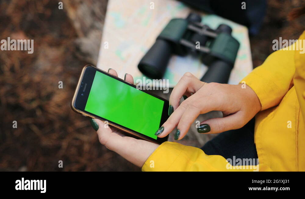 Close up of woman's hand scrolling and zooming on the black smart phone ...