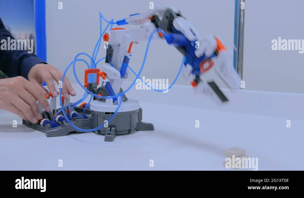 Woman controls robot hand manipulator at technology exhibition Stock ...