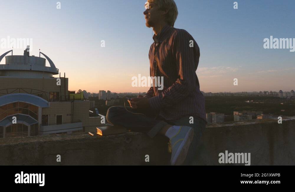 Man sitting roof Stock Videos & Footage - HD and 4K Video Clips - Alamy