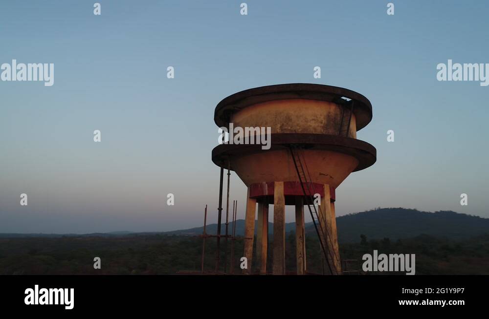 Flying around a water tower in a small Indian village. Aerial view ...