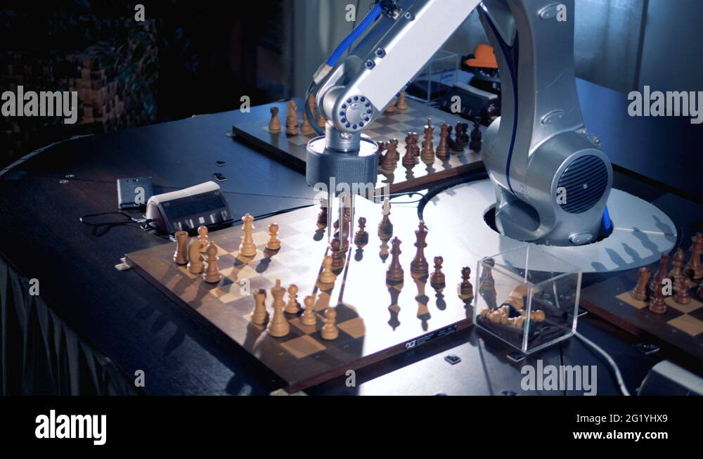 A robotic arm is moving chess pieces and pressing the chess clock Stock ...