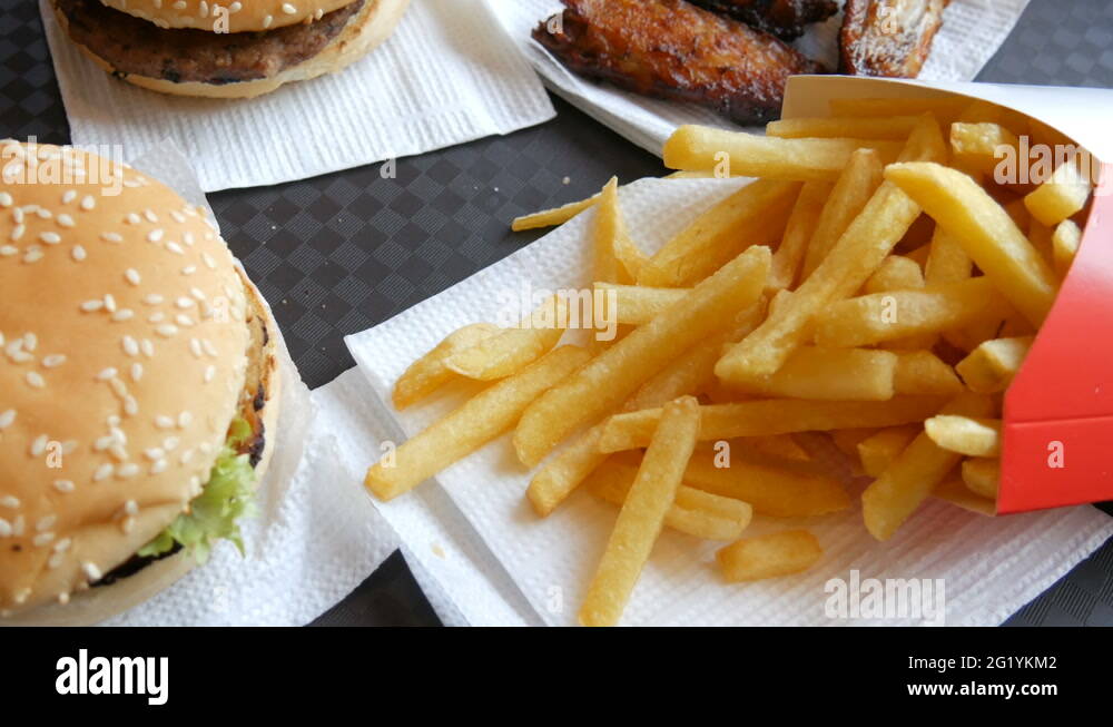 On tray is fast food. Not healthy food on the table burgers, french ...