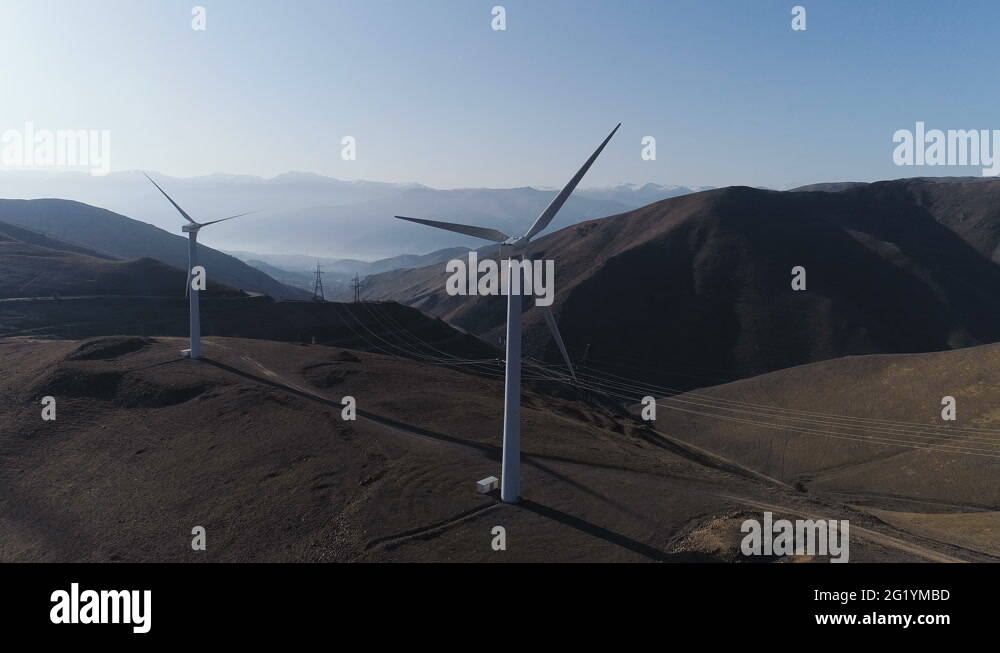 Wind turbines create renewable energy Cooling tower of power plant in ...