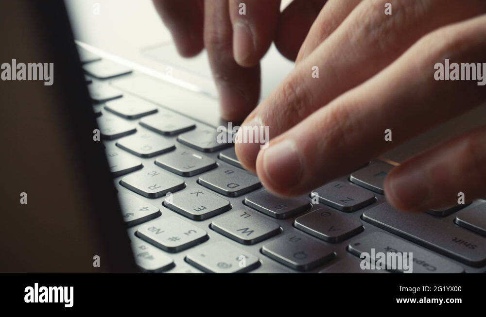 Laptop keyboard typing. Close up shot of hands touch typing on a laptop ...
