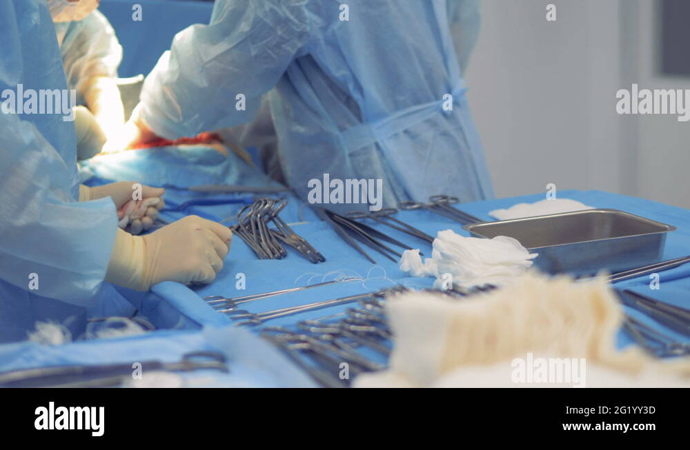 Nurse's hands taking surgical scissors during surgery in hospital Stock ...