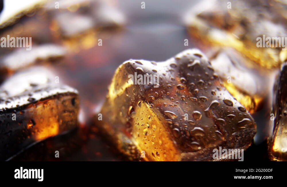ice cubes in a glass of coke and bubbles rising Stock Video Footage - Alamy