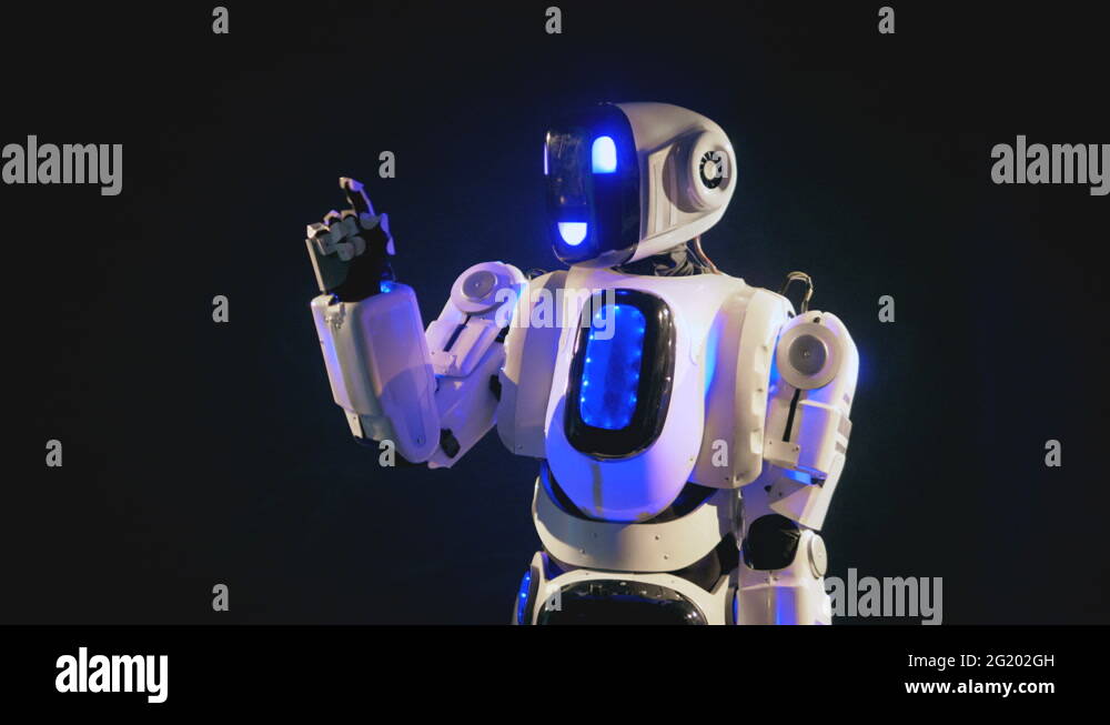 White cyborg stands, while dialling numbers on ivisible board with both ...