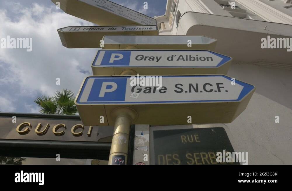 Low angle of road signs in front of Gucci shop Stock Video Footage - Alamy