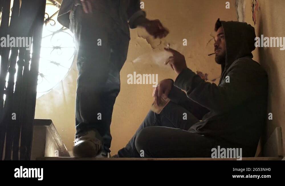 Portrait Of Drug Dealing Drug Dealer Sitting On The Stairs Sells Drugs Stock Video Footage Alamy
