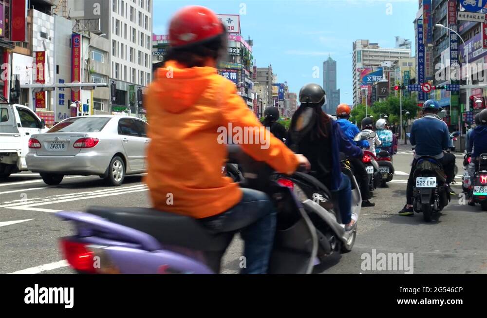 Kaohsiung - Street view. Motorbikes queuing by traffic lights. 4K Stock ...