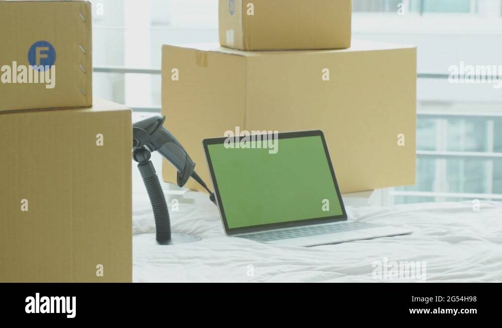 laptop computer with green screen chroma key with cardboard boxes ...