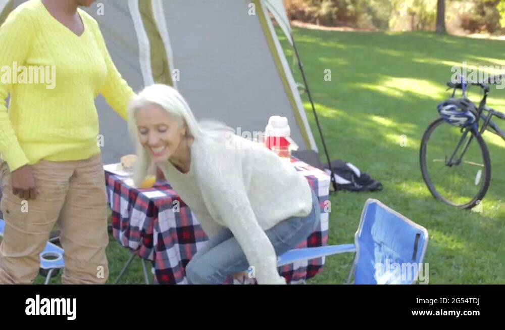 Two Mature Women On Camping Holiday Set Off On Cycle Ride Stock Video ...