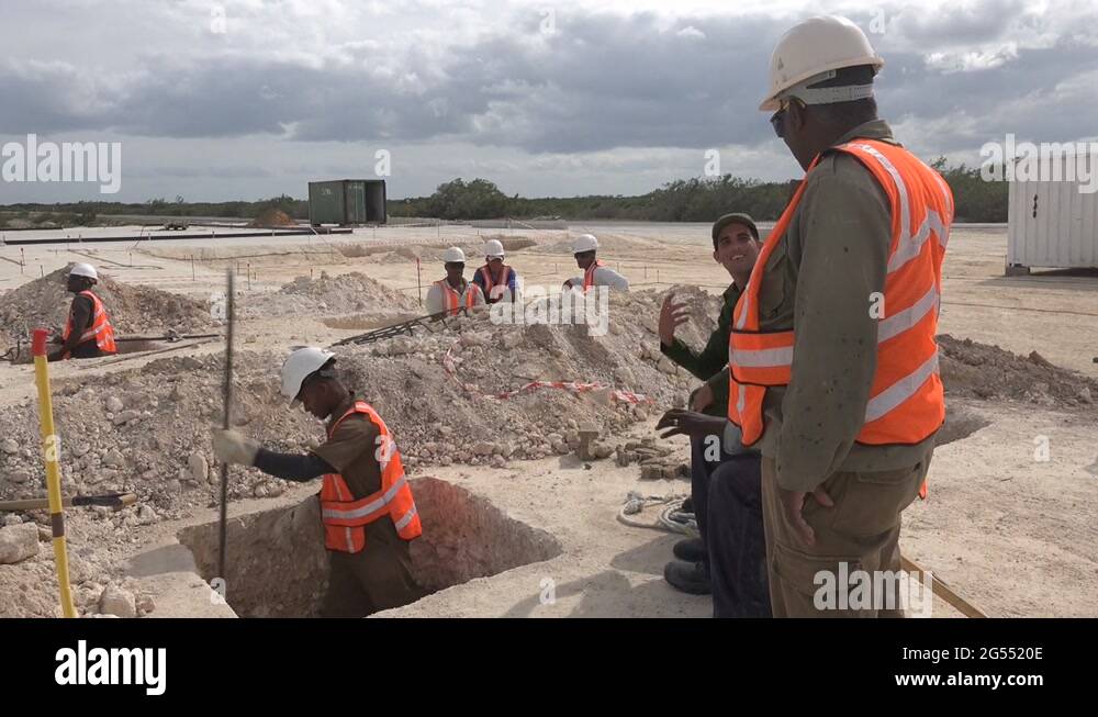 Cuban construction workers at a site for new beach hotel resort complex ...