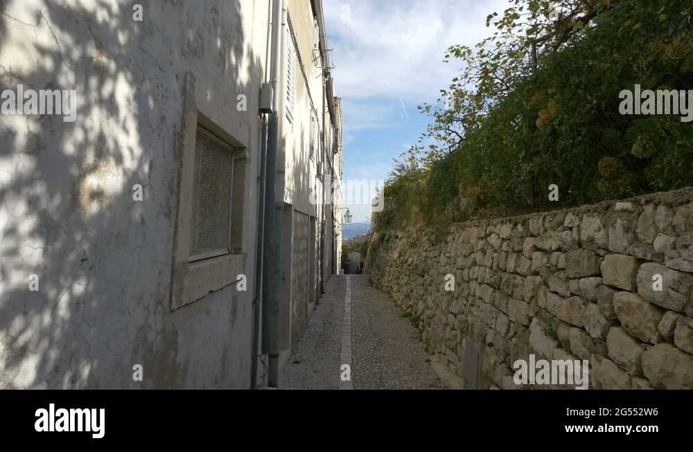 Narrow street stone wall Stock Videos & Footage - HD and 4K Video Clips ...