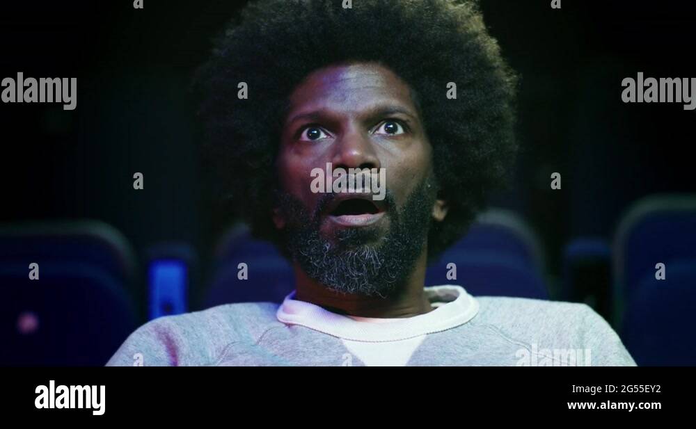 Man at the movie theatre is awestruck by an incredible moment. Slow ...