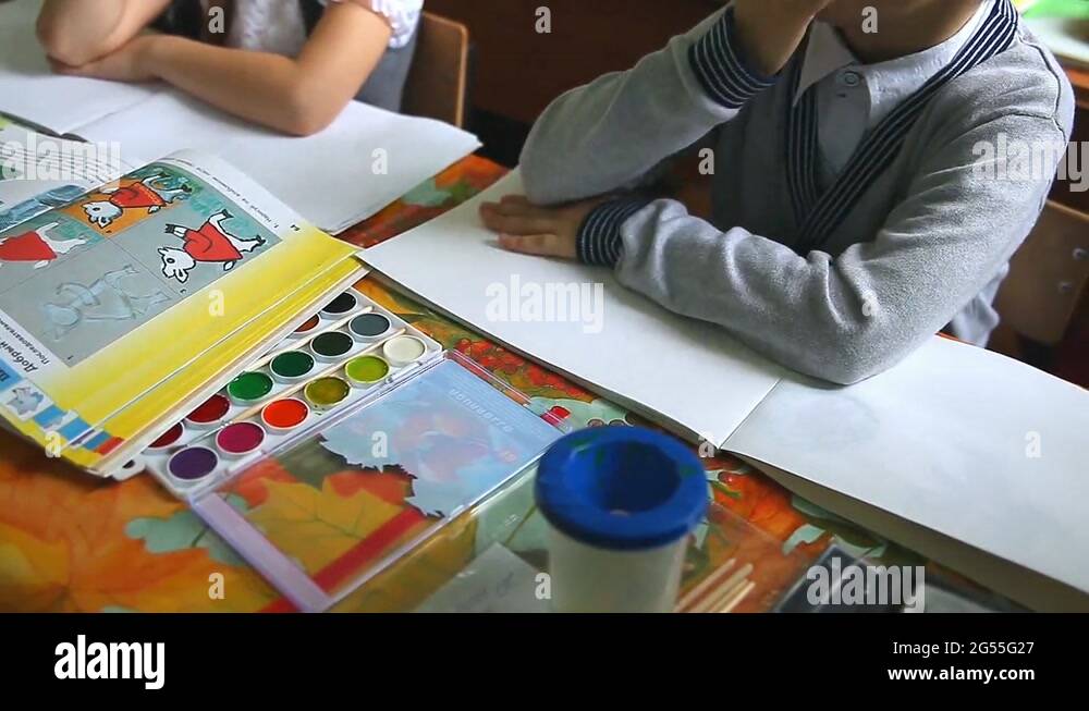 children in the class draw paints in an album drawing lesson School ...