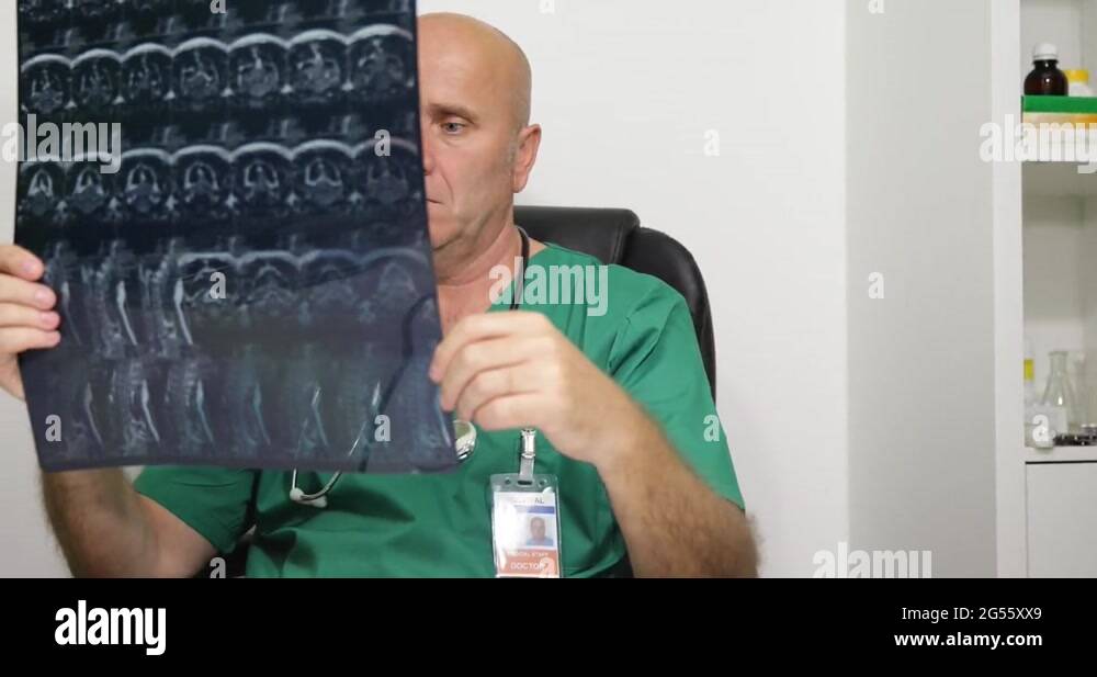 Pan View of Disappointed Doctor Examining Radiography Image Give Bad ...