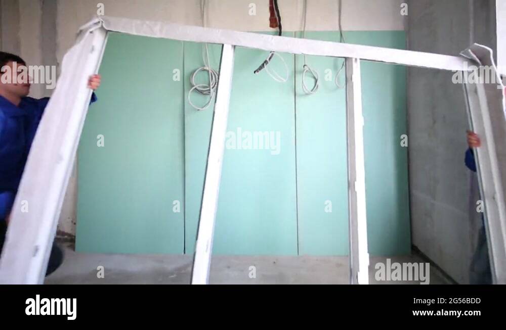 Two workers move window frame and put it to wall Stock Video Footage ...