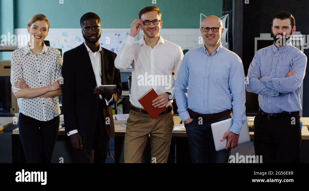 Portrait of mixed races office team posing in the modern office space ...