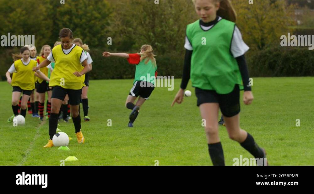 4K Young girls training with the coach at British soccer training ...
