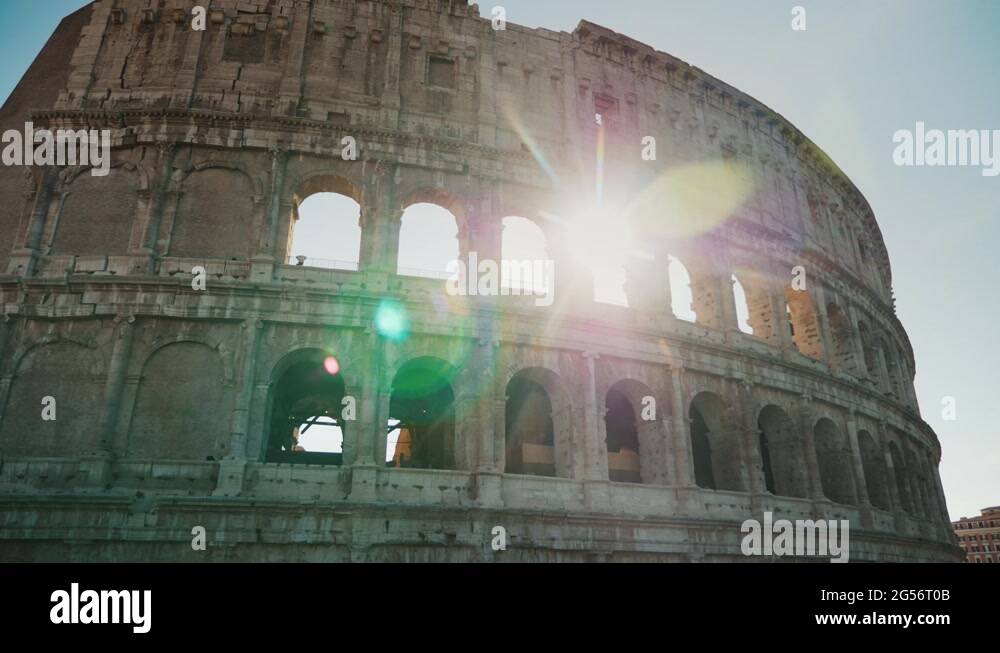 The sun shines beautifully through the arches of the Colosseum in Rome ...