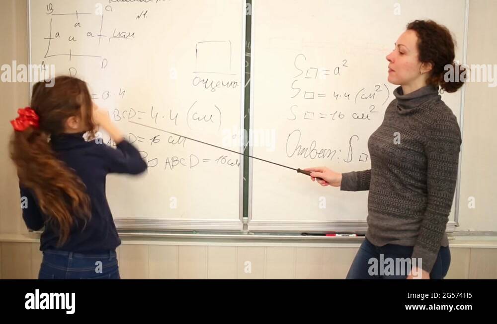 Girl explaining problem solution to woman teacher with pointer Stock ...